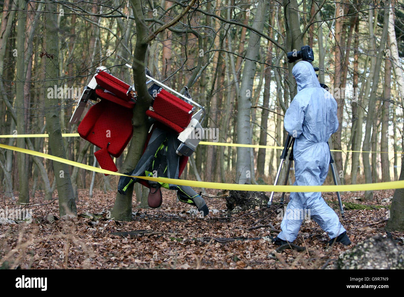A police photographer takes pictures of a 'body' and 'wreckage' during ...