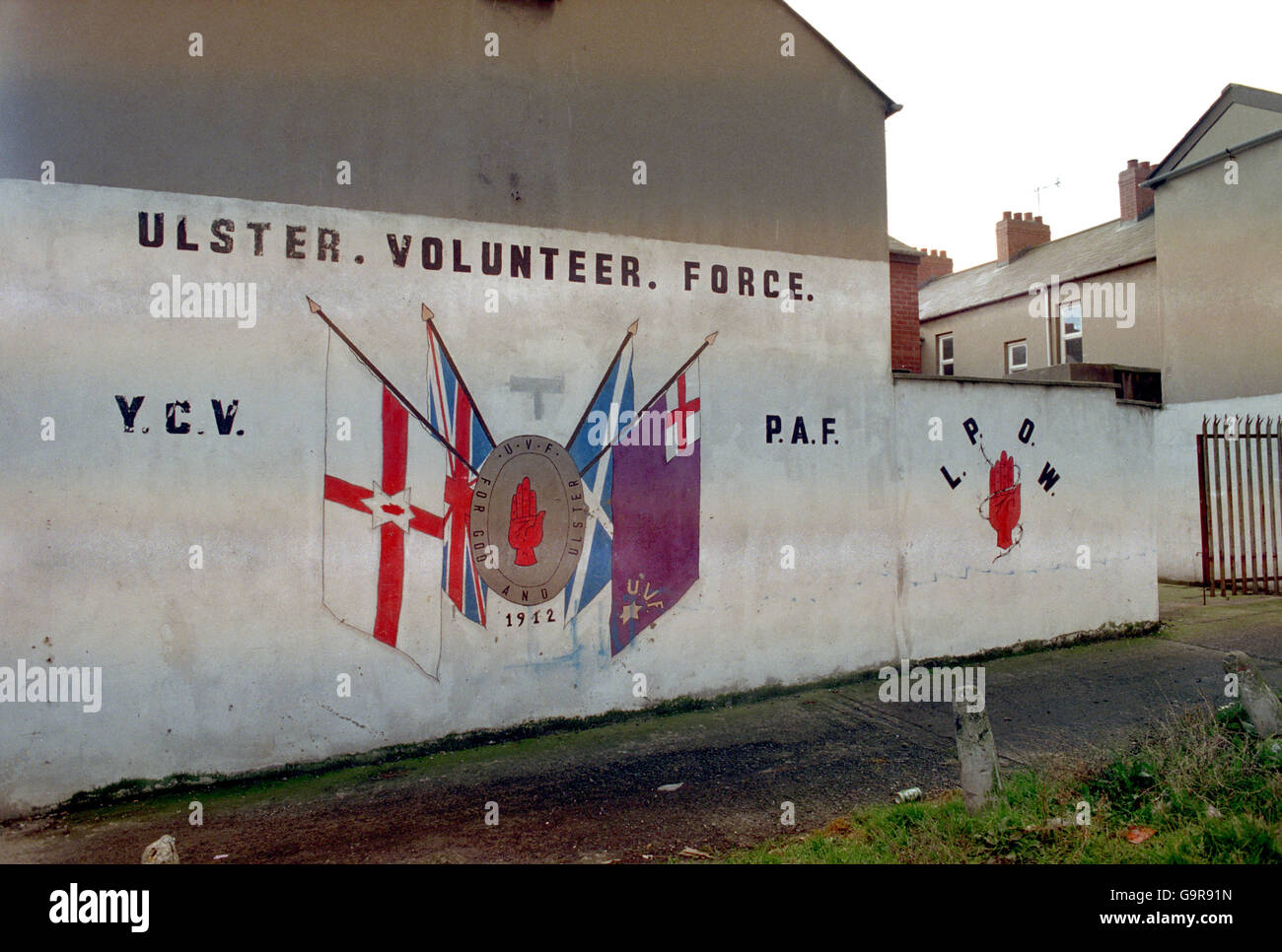 Loyalist Mural in Belfast on the wall of a house showing flags and the ...