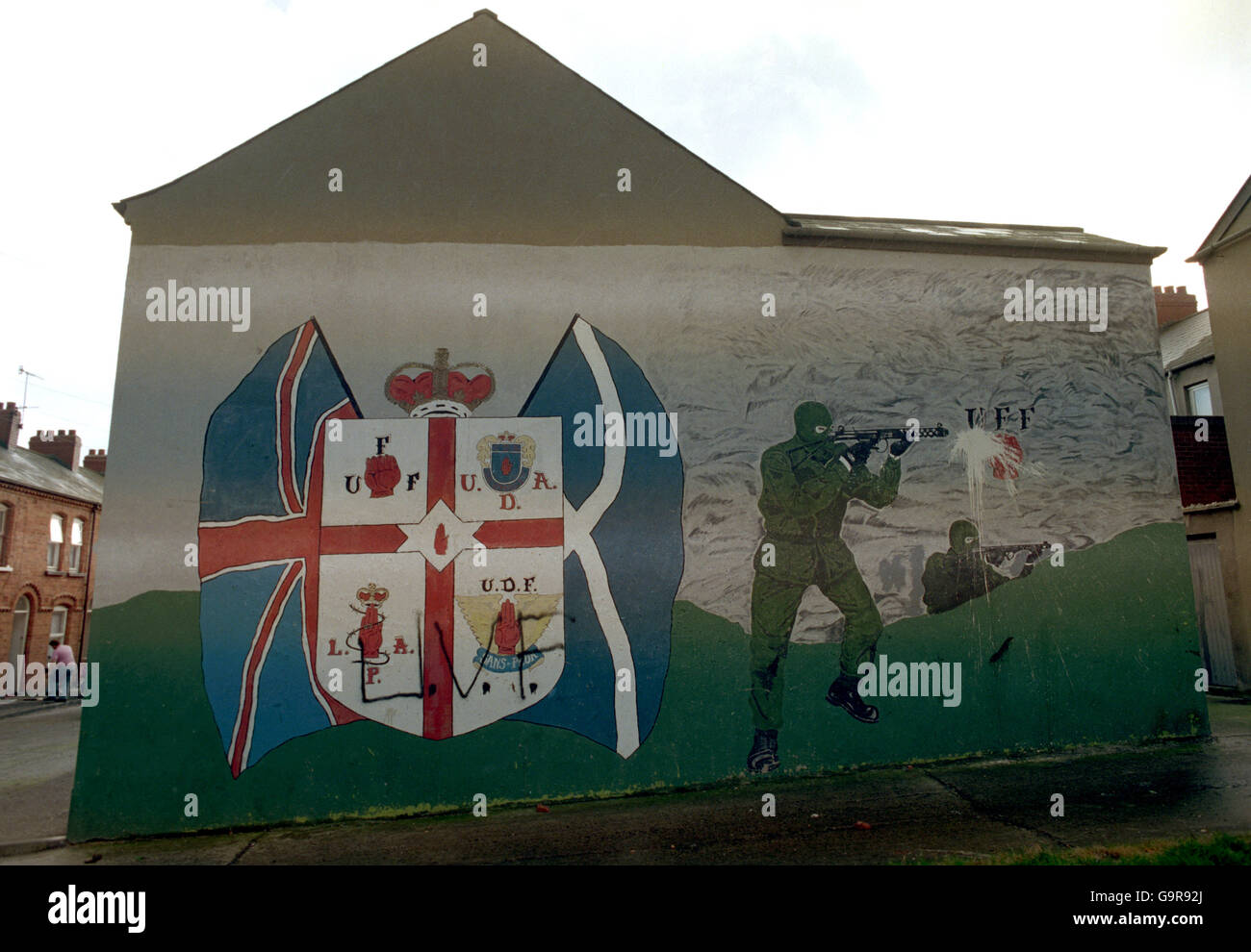 Loyalist mural on Belfast wall showing soldiers and various flags and a ...