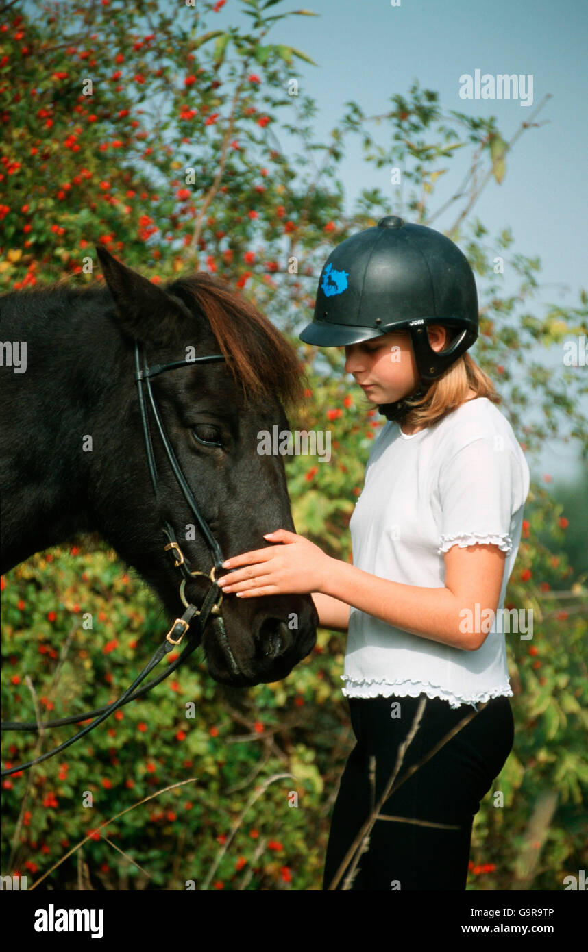 Girl with Icelandic horse / crash helmet, riding helmet Stock Photo - Alamy