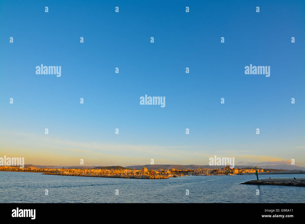 panoramic view of Alghero under a blue sky at sunset Stock Photo - Alamy