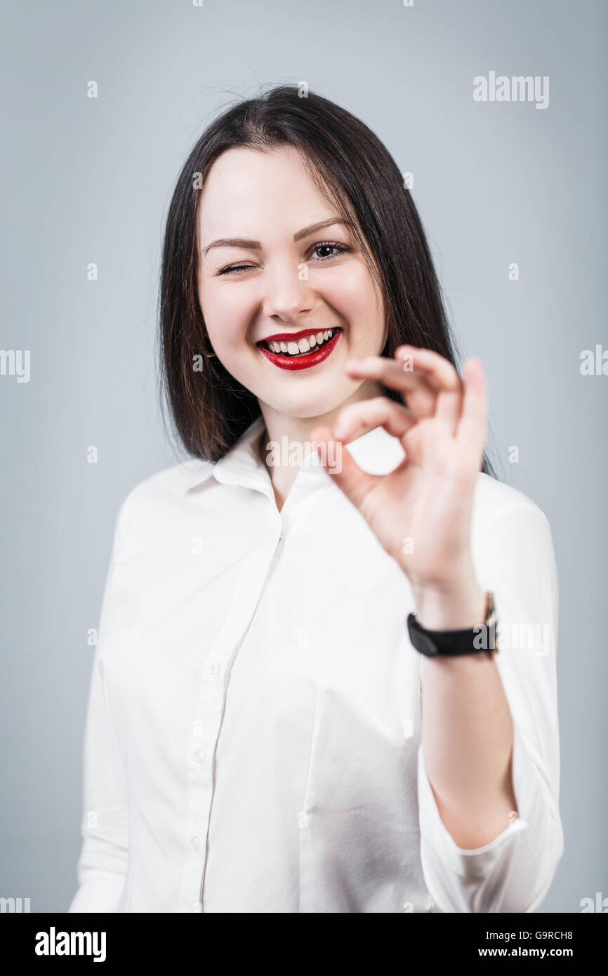 Young beautiful woman shows OK sign Stock Photo - Alamy