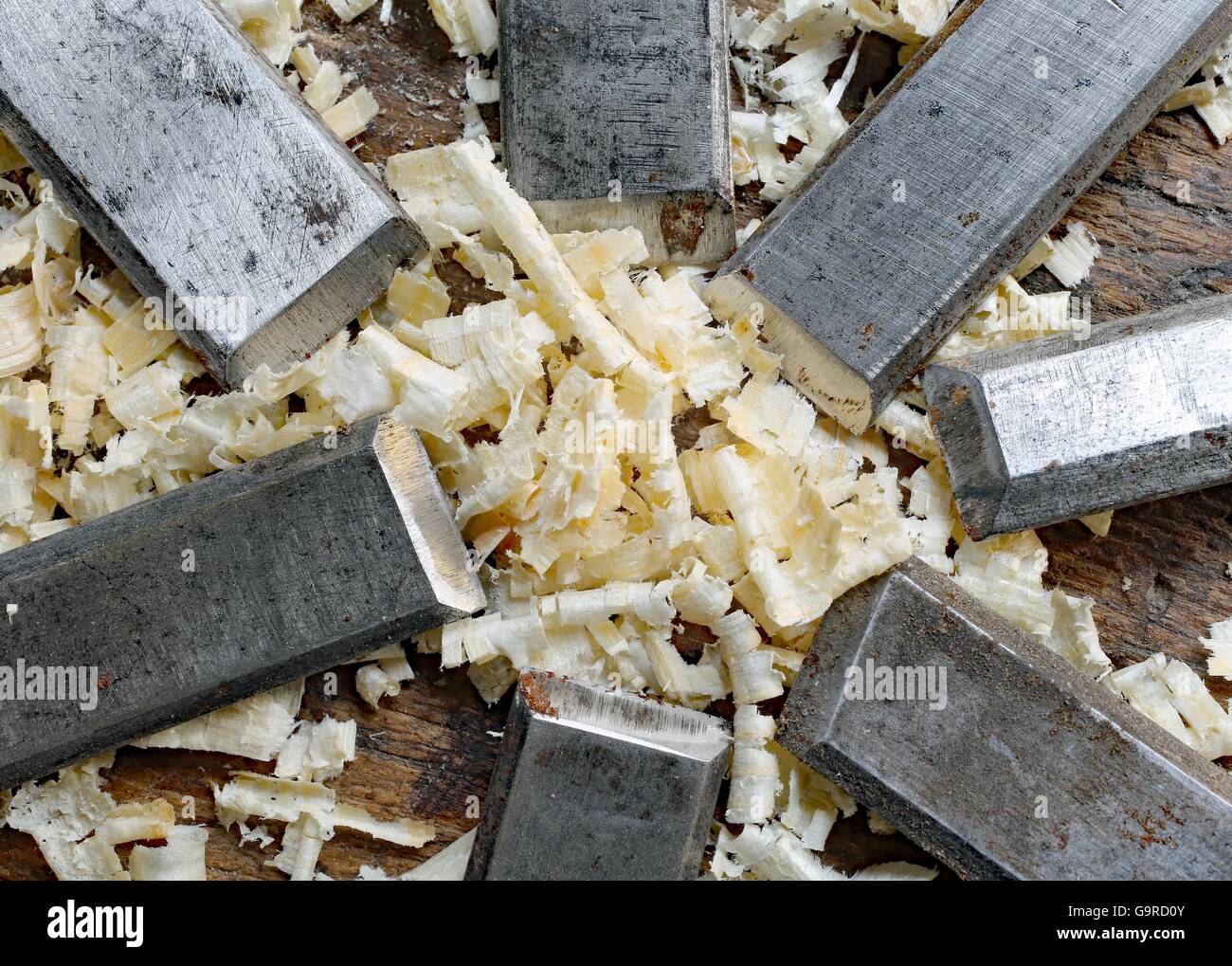 series of many sharp steel blades many chisels and sawdust chippings in ...