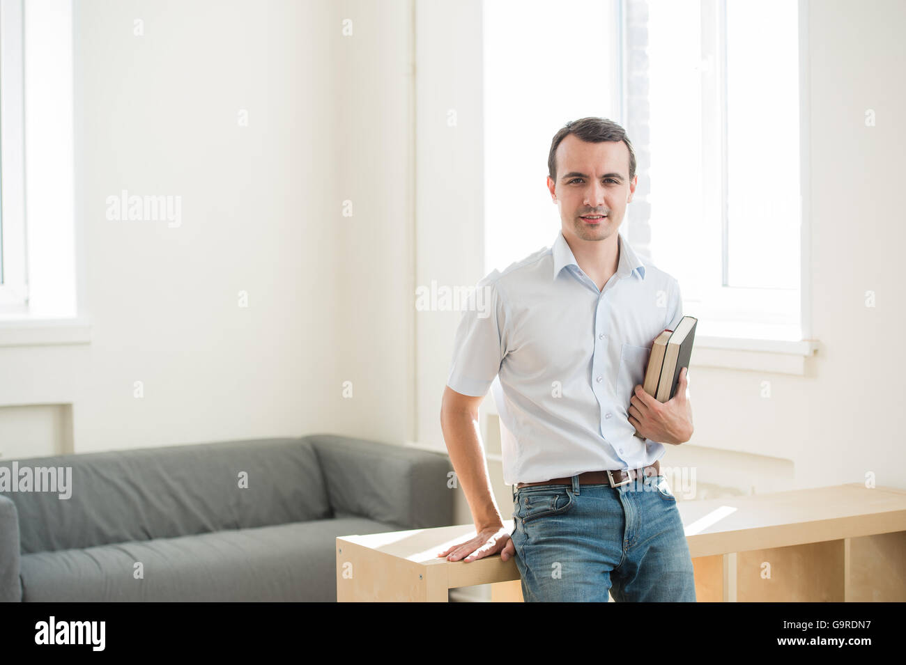 Closeup portrait, young business man or teacher in blue shirt reading ...
