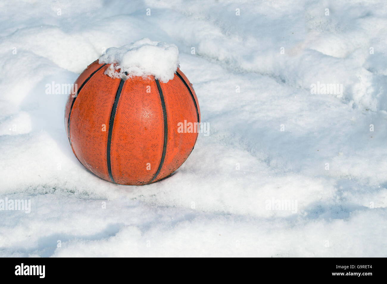 basketball on a playground covered by snow Stock Photo - Alamy