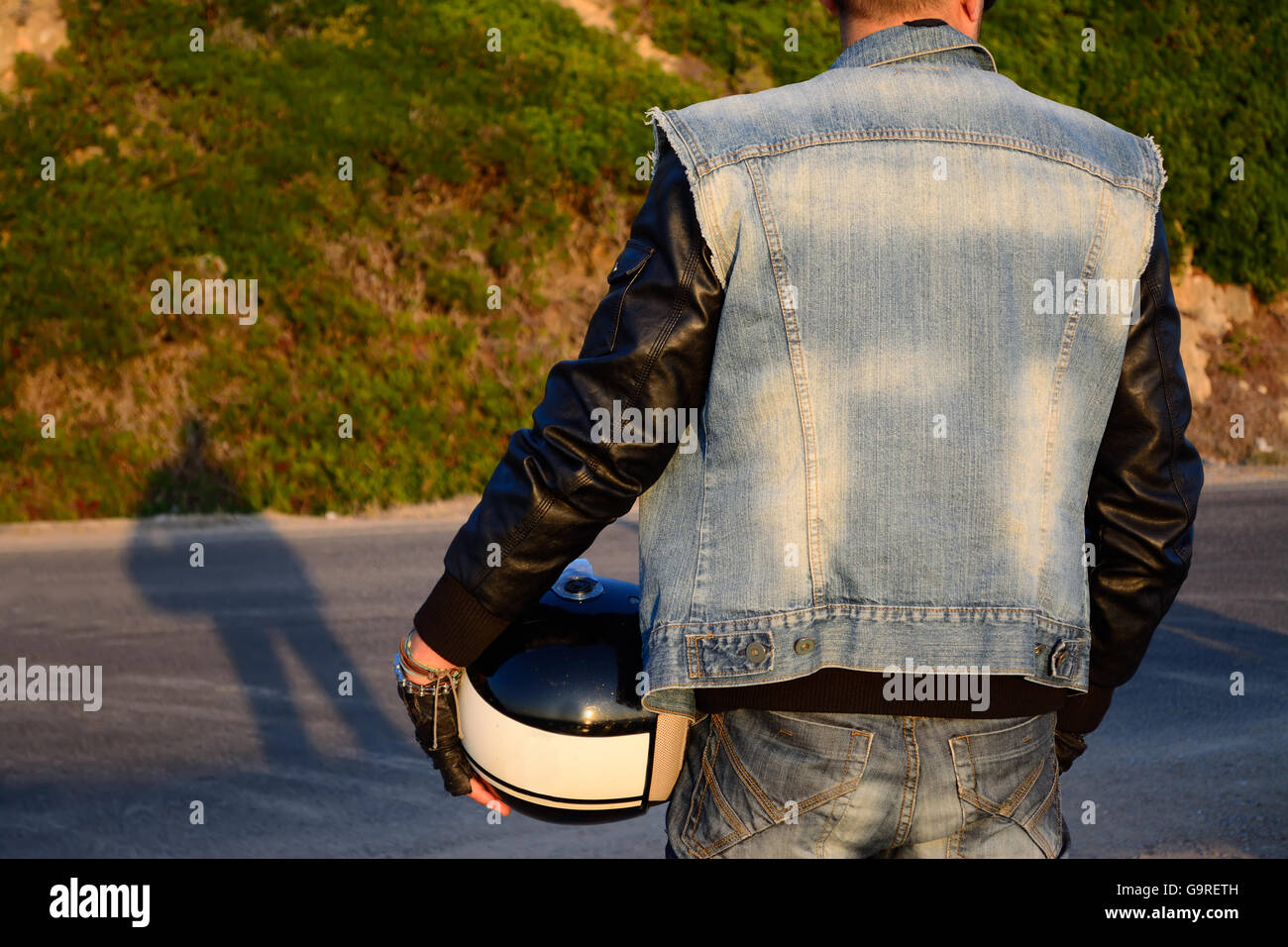 back view of a biker on the edge of the road at sunset Stock Photo - Alamy