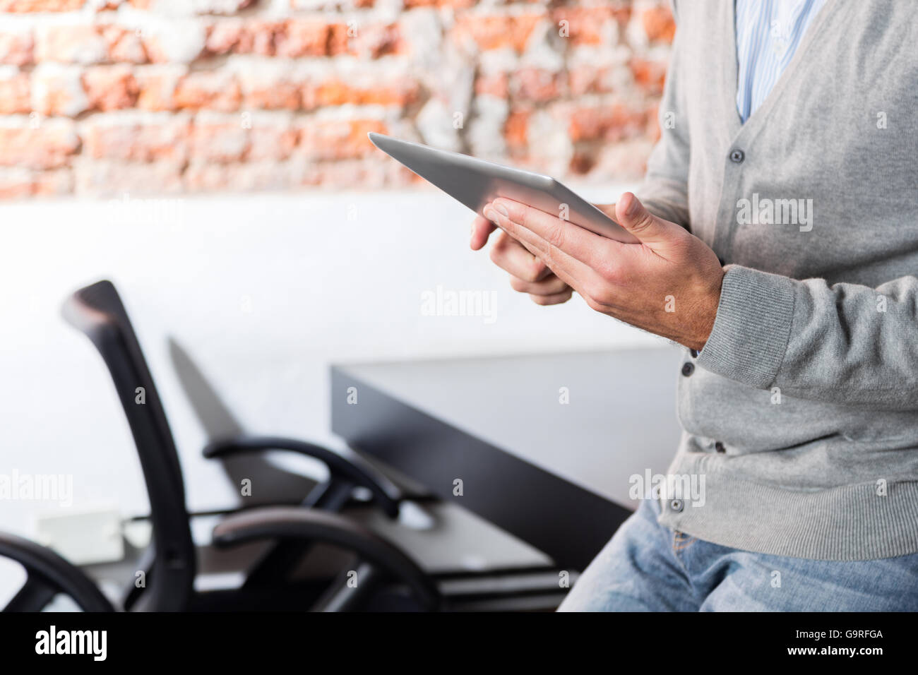 Person using tablet sitting office desk business man Stock Photo - Alamy