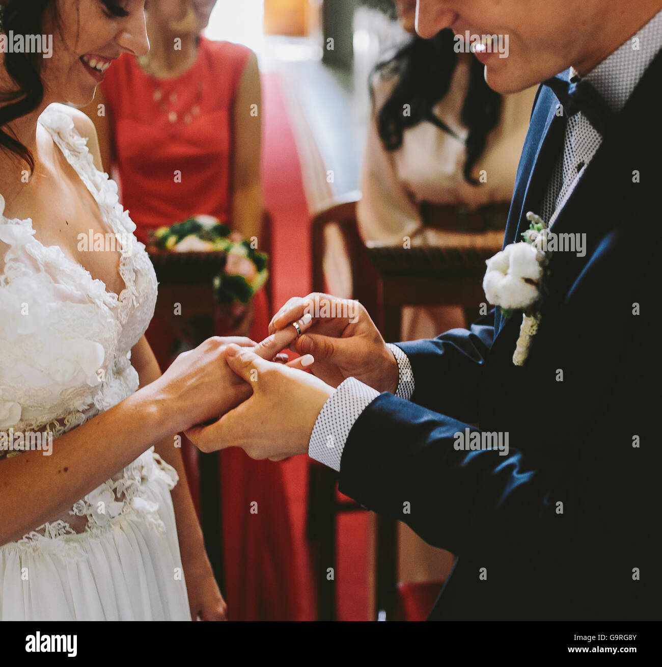Putting the wedding ring on Stock Photo - Alamy