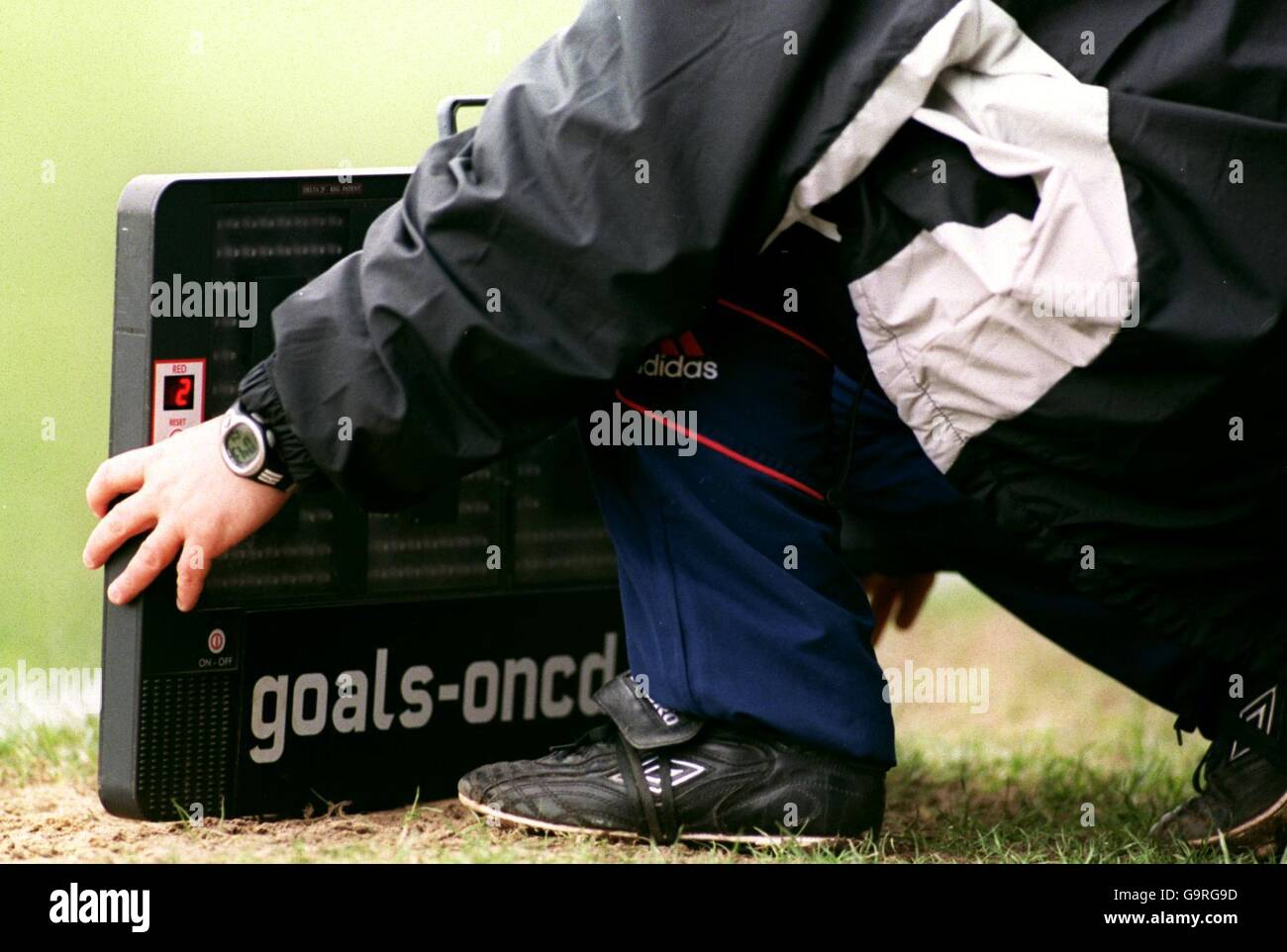 The fourth official sets the electronic board to display two minutes of ...