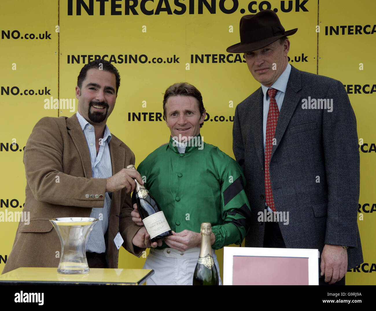 Jockey Jimmy Fortune (centre) and trainer John Gosden (right) receive ...