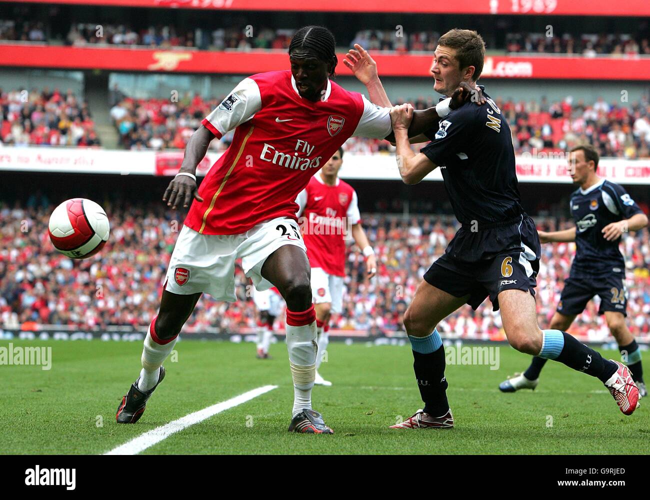 West Ham United's George McCartney (r) and Arsenal's Emmanuel Adebayor ...