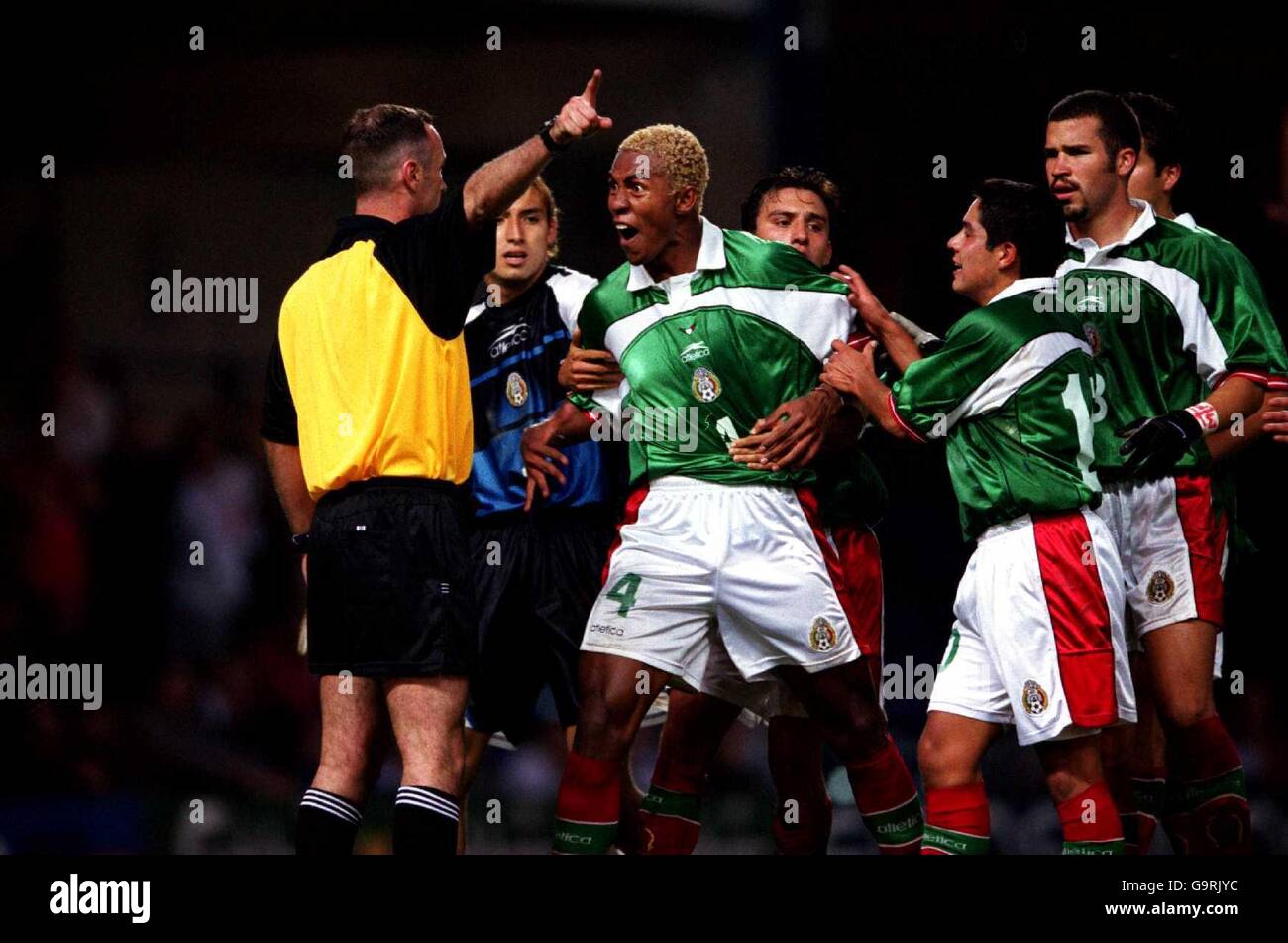 Referee Michael McCurry (l) sends off Mexico's Edourdo Isella (c) who ...