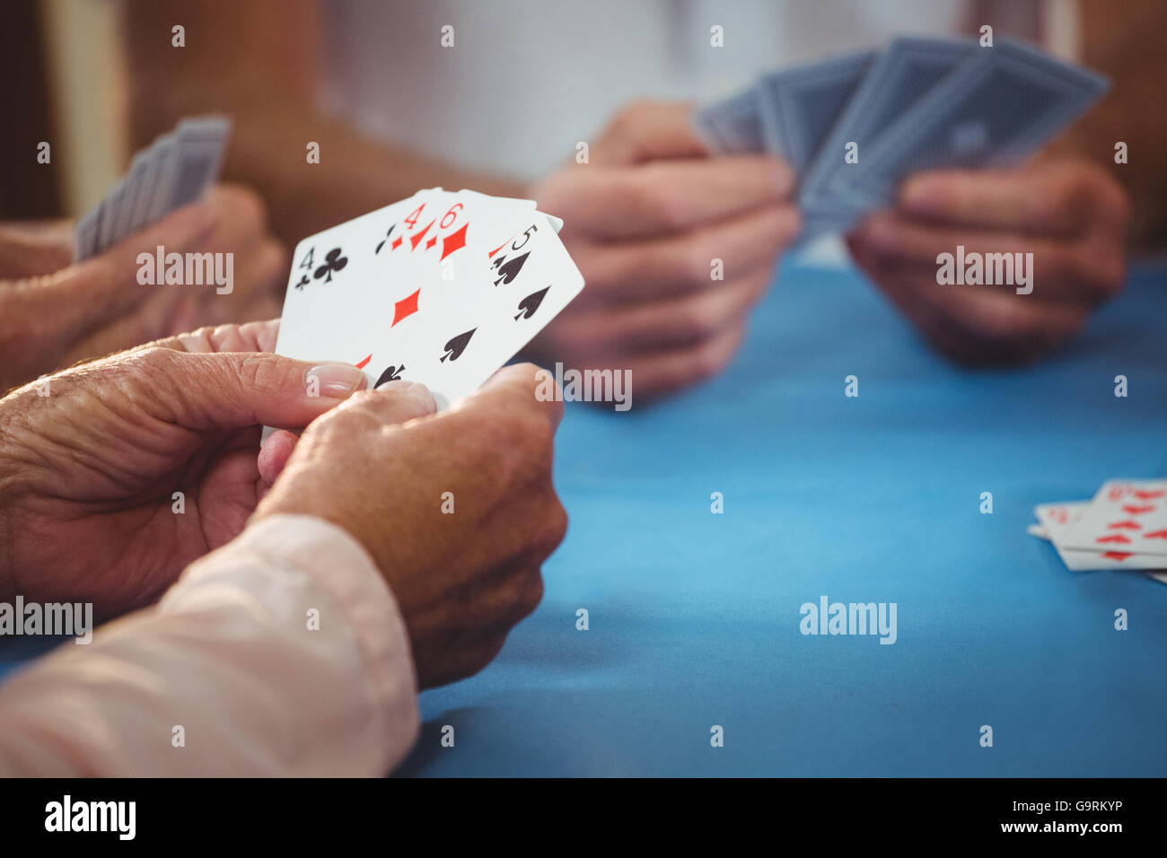 Retired people playing card Stock Photo - Alamy
