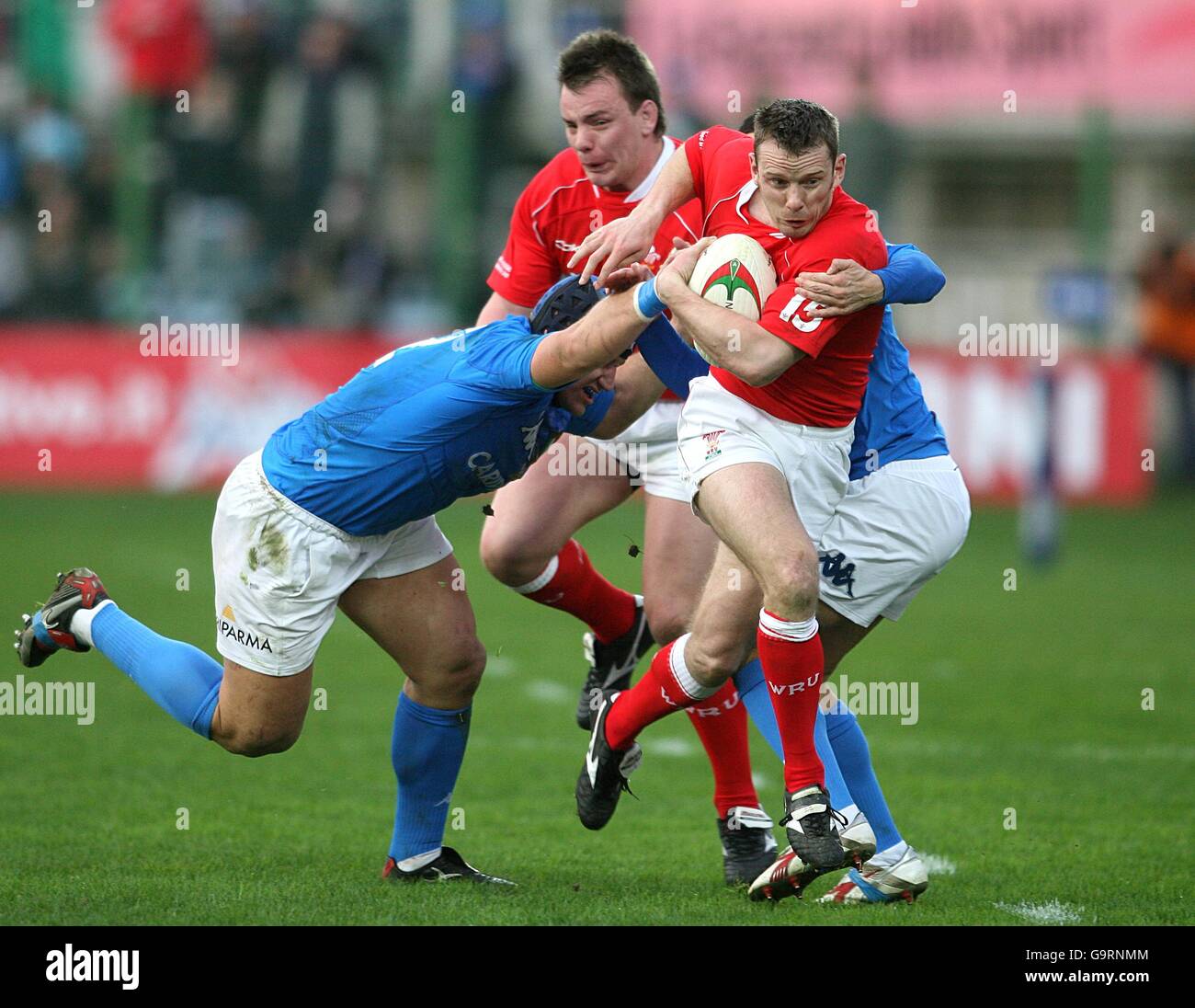Wales' Kevin Morgan tries to break through the Italy tackle Stock Photo ...