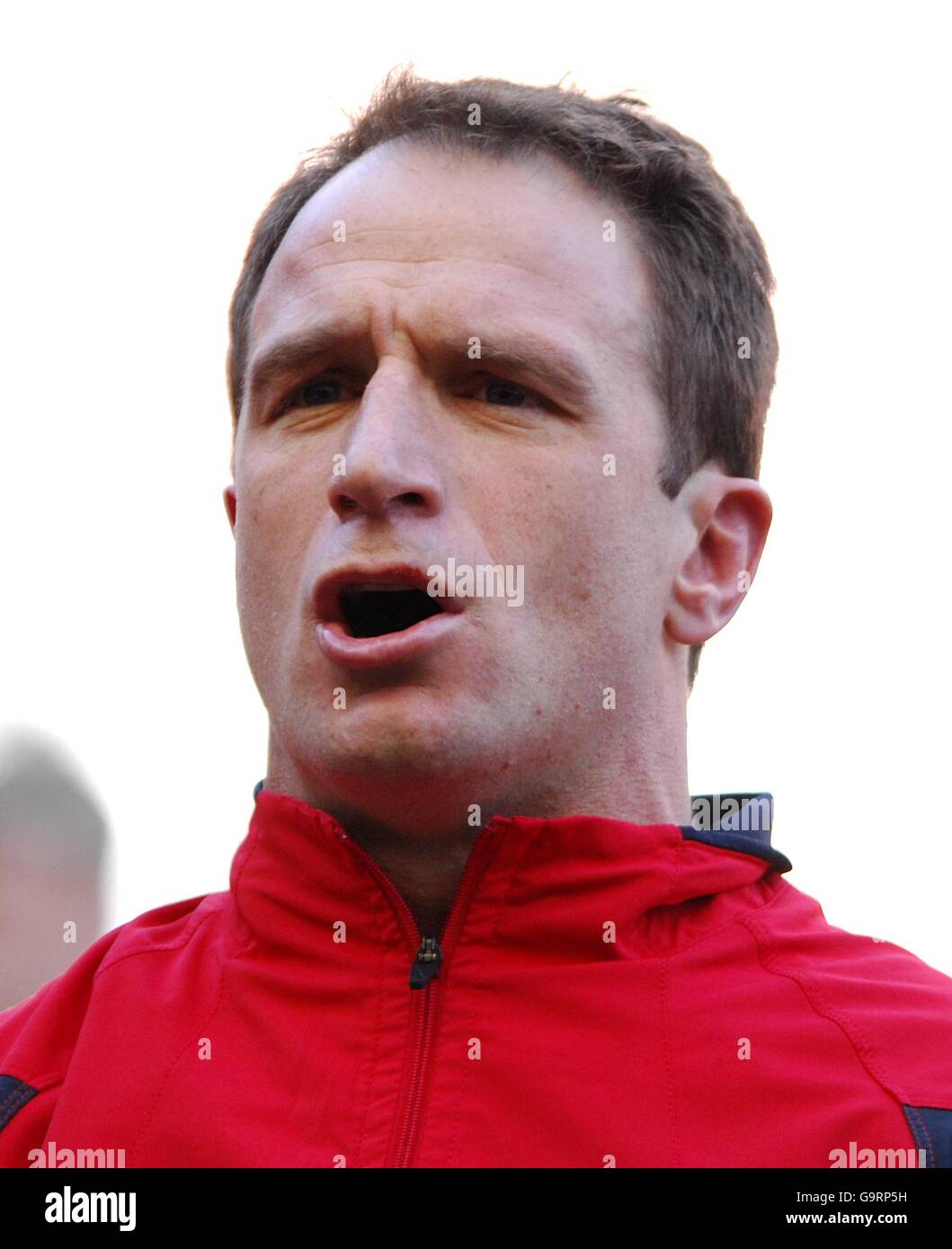 Emgland's Mike Catt sings the national anthem as he captains the side ...