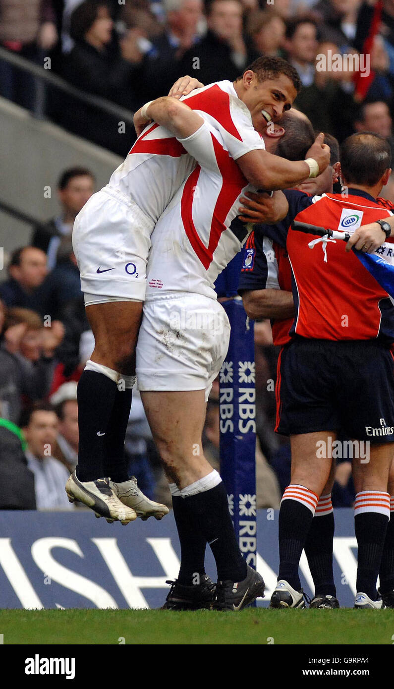 Full length hugging happy celebrating celebrates achievement winners ...