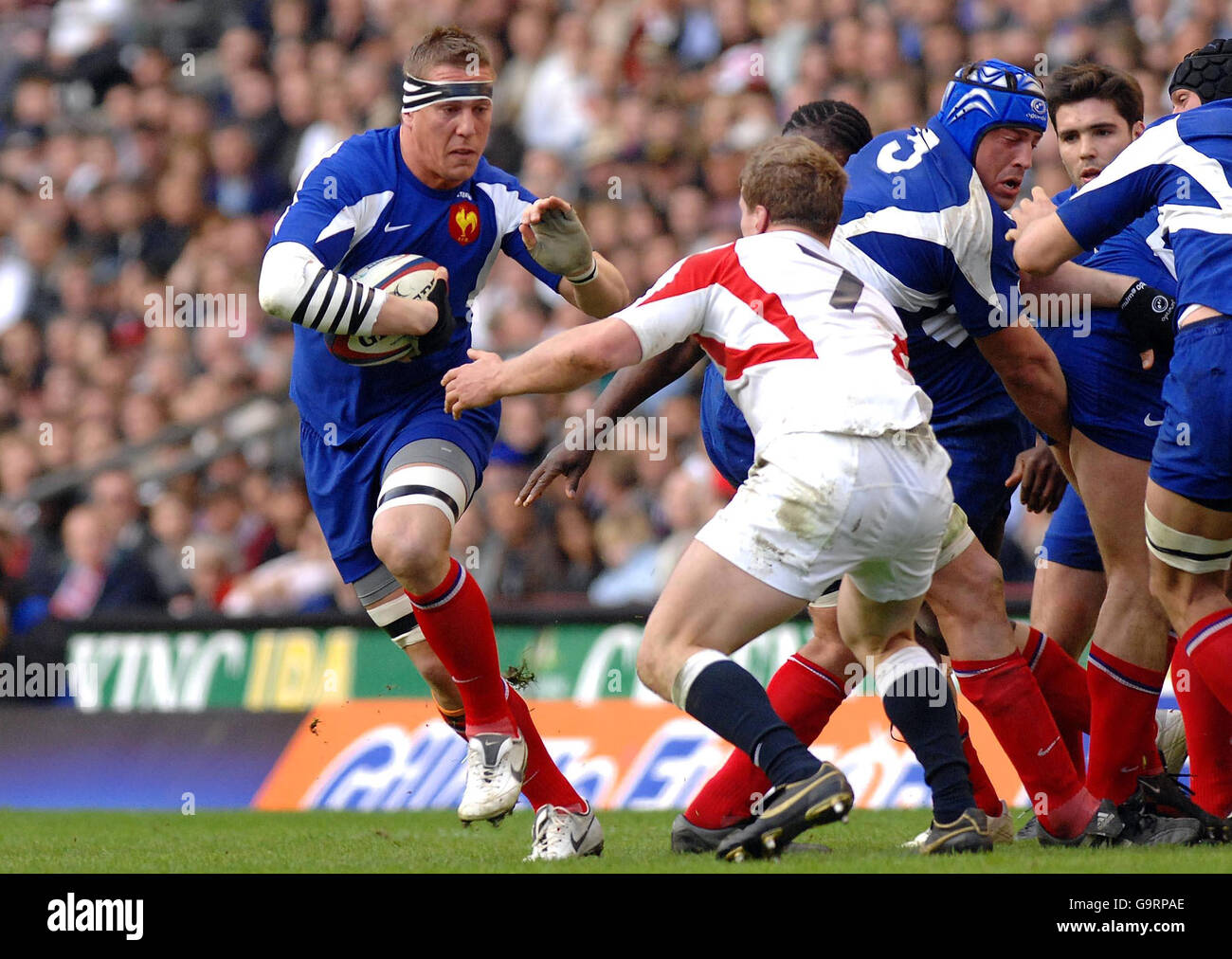 France's Imanol Harinordoquy (left) is confronted by England's Tom Rees ...