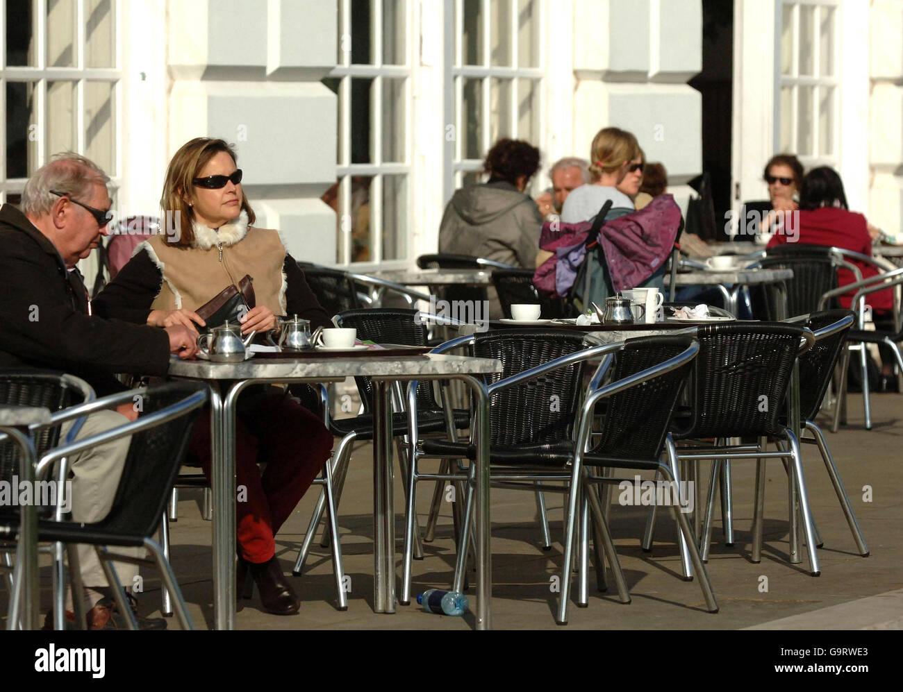View of garden visitors having tea outside in the sunshine, in Kew ...