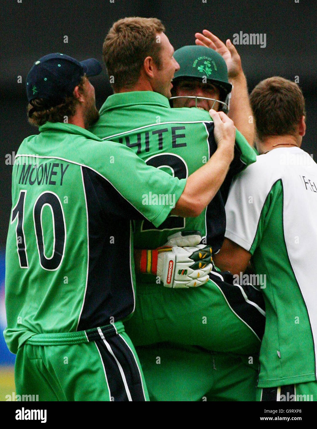 Irish captain Trent Johnston (helmet) is mobbed by team-mates after ...