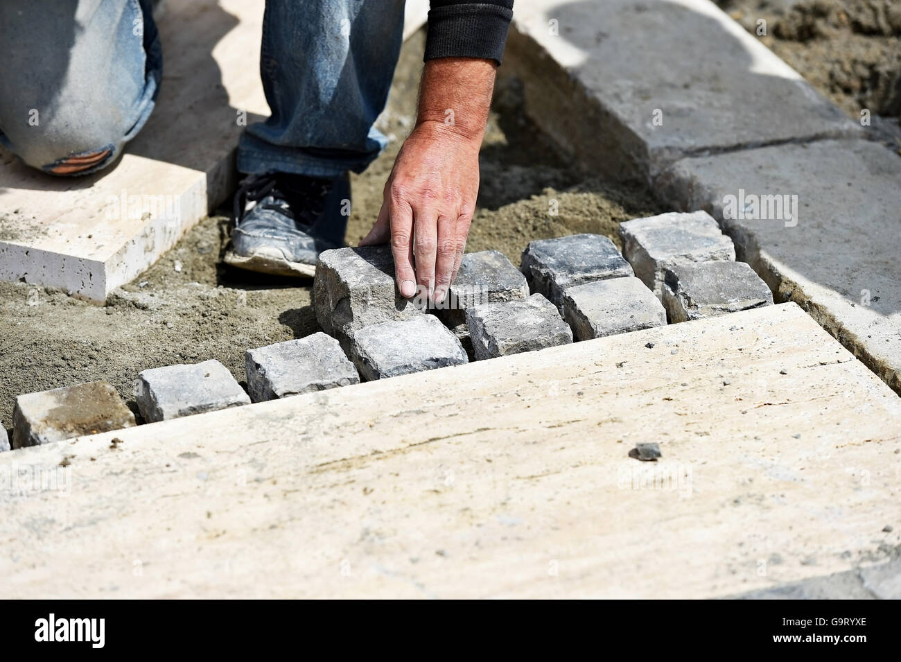 Detail with installation works of cobblestone by a mason Stock Photo ...