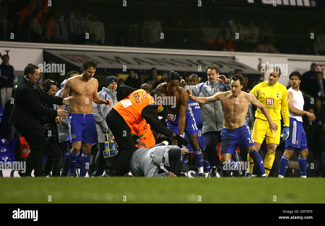 A pitch invader runs onto the pitch at the end of the match, and is ...