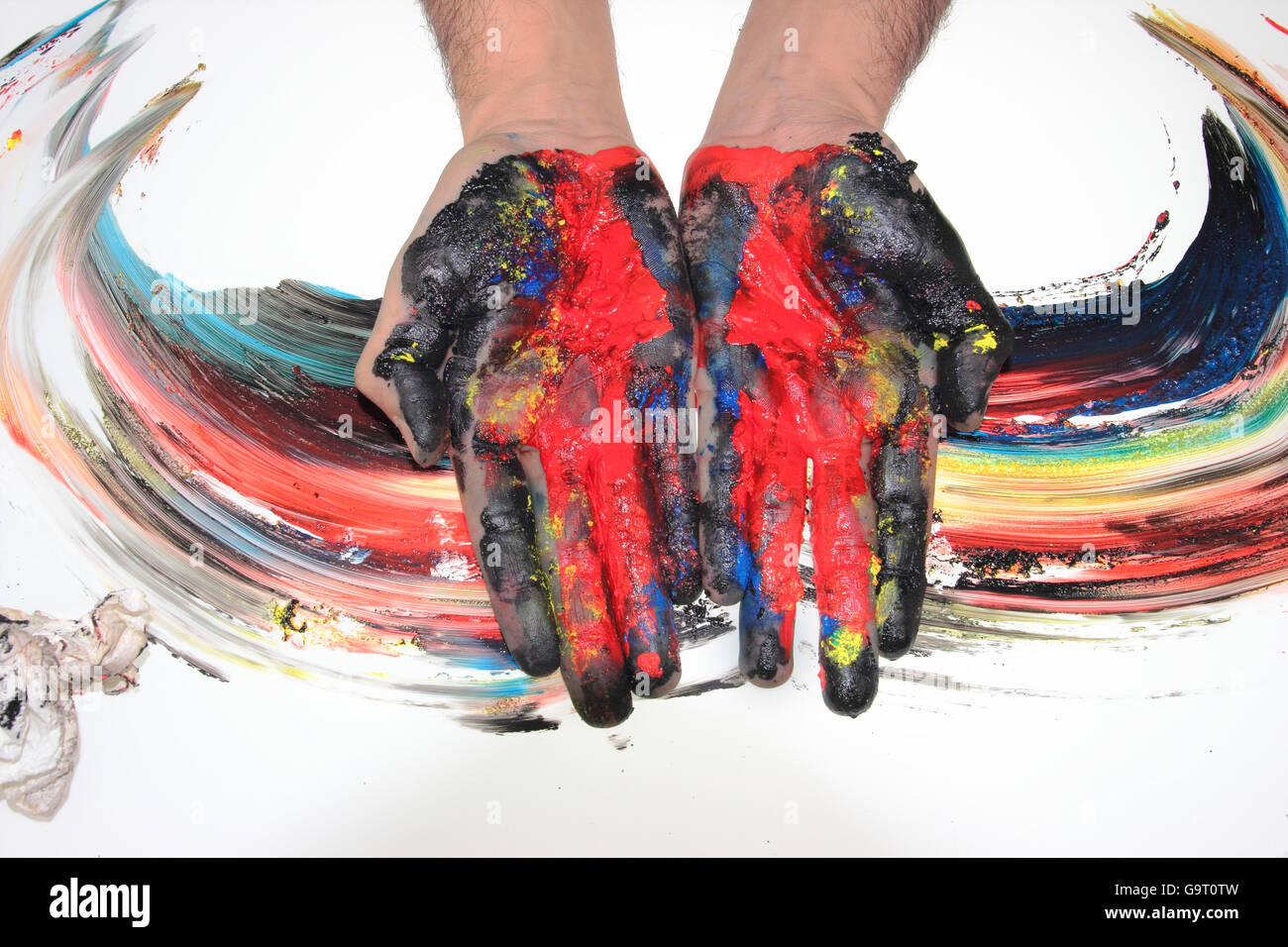 two painted colorful hands against white background Stock Photo - Alamy