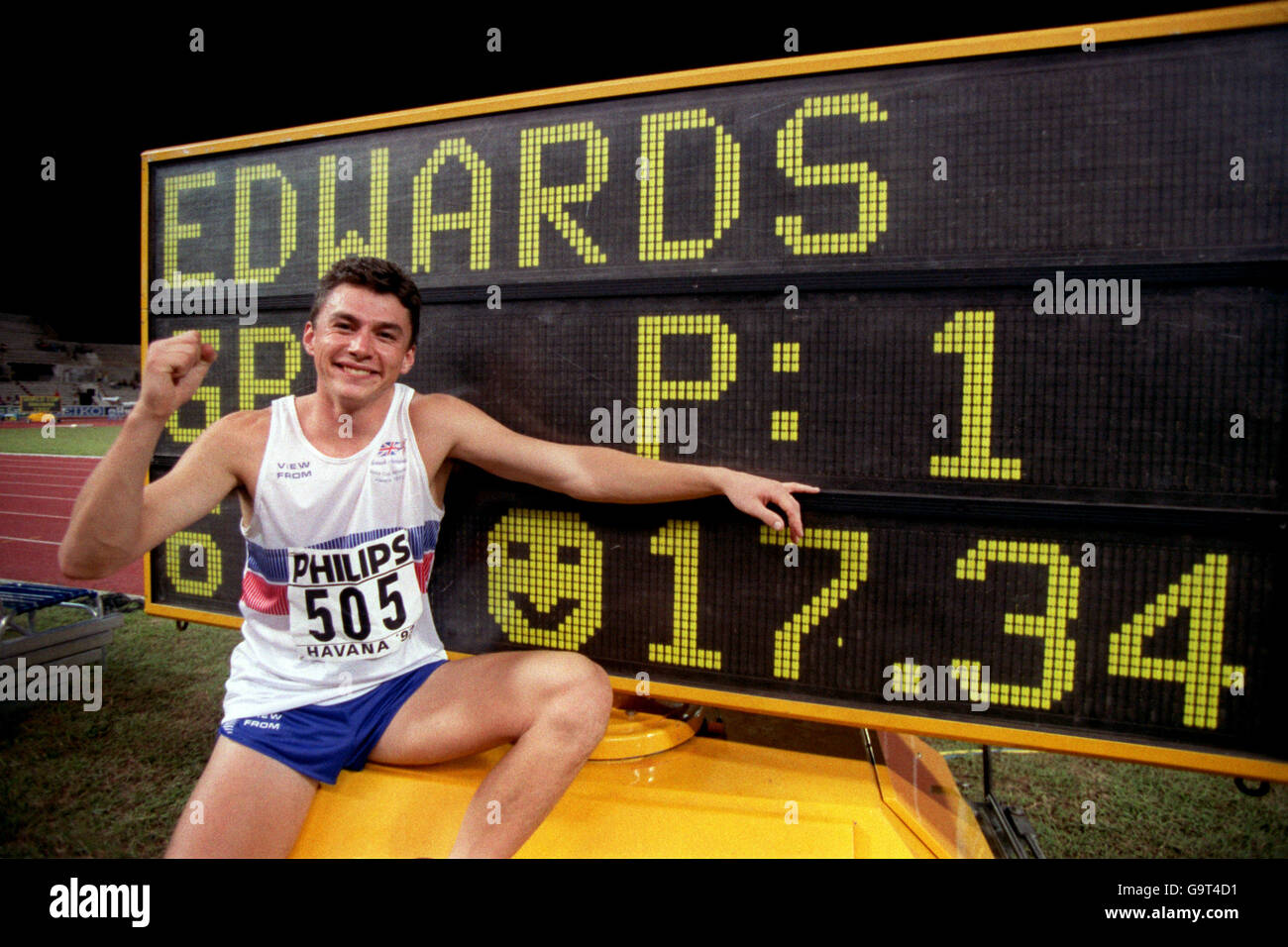 Great Britain's Jonathan Edwards sits next to the scoreboard showing ...