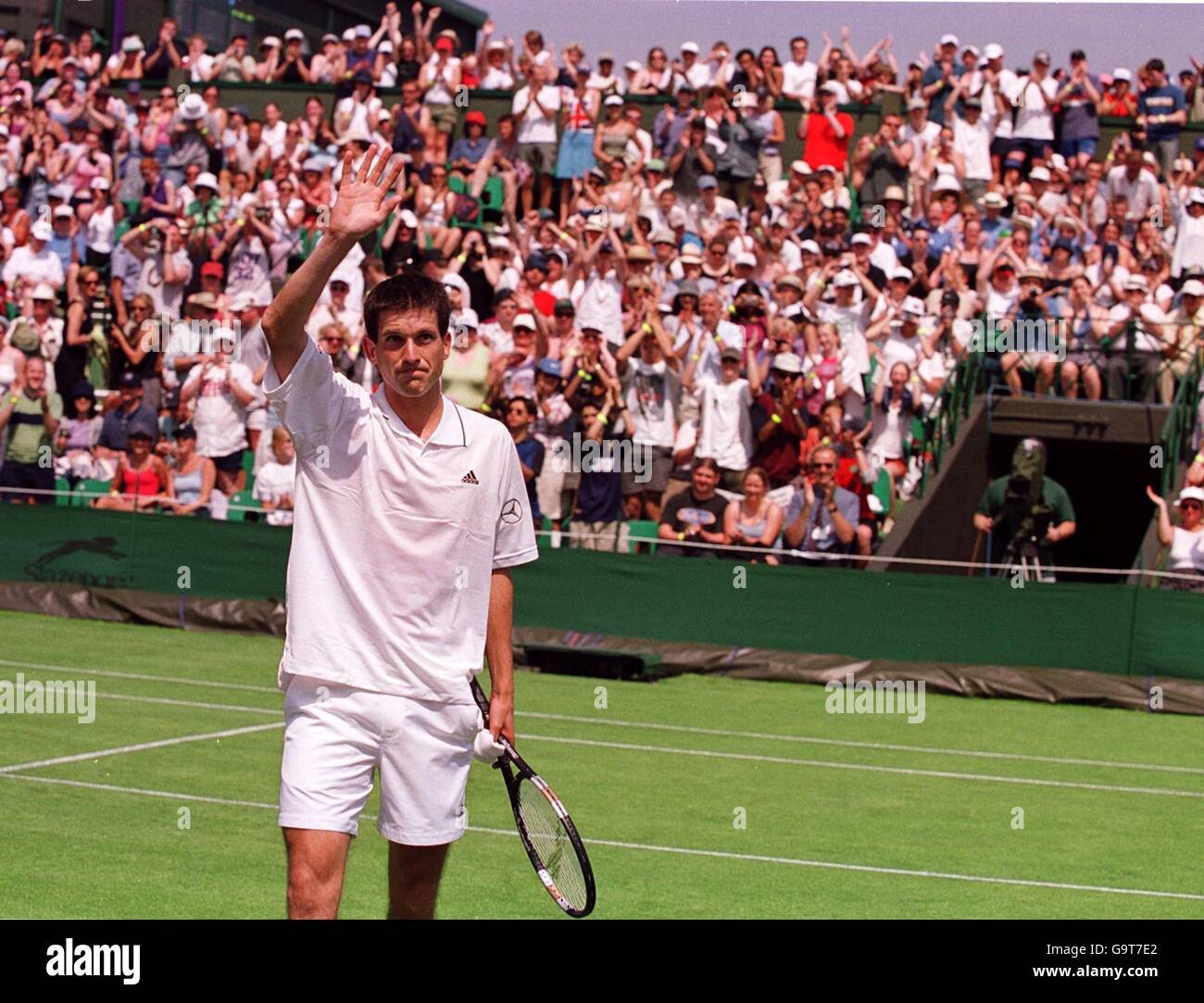Tim Henman celebrates his first round victory at Wimbledon Stock Photo ...