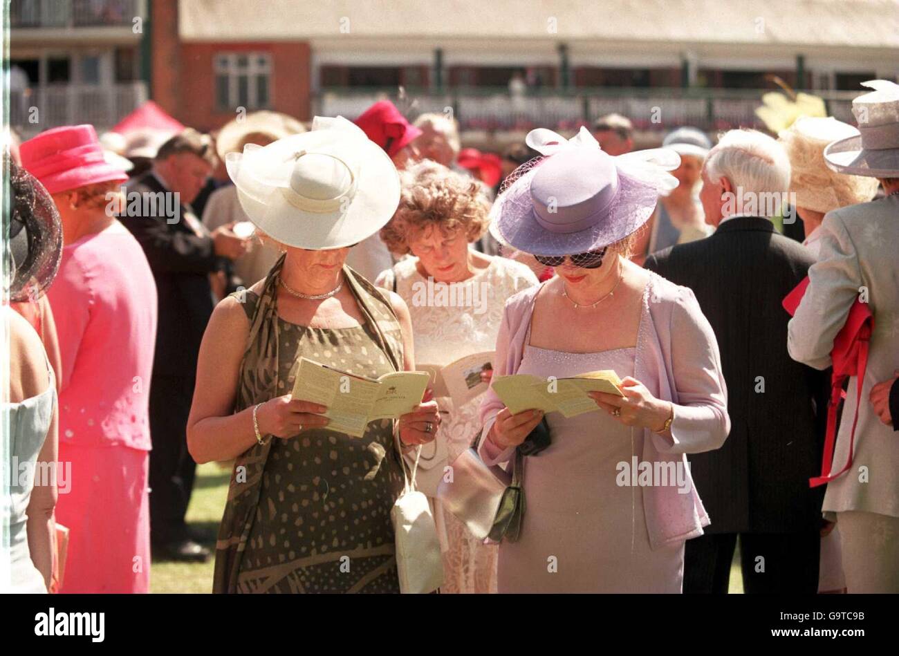 Female racegoers reading their programmes hi-res stock photography and ...