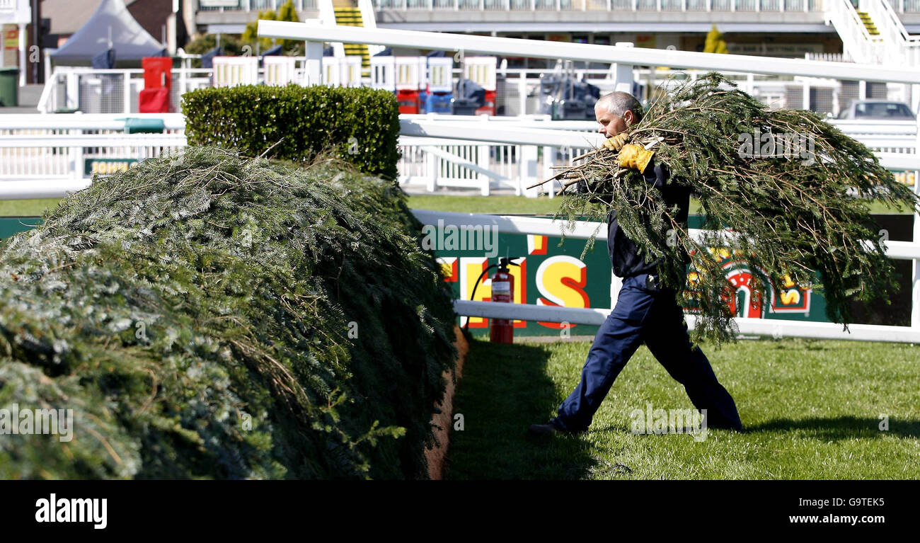 Racing - Aintree Racecourse. Groundstaff prepare the water jump fence ...