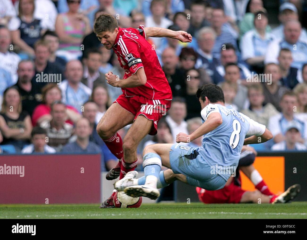 Manchester City's Joey Barton tackles Liverpool's Steven Gerrard (left ...