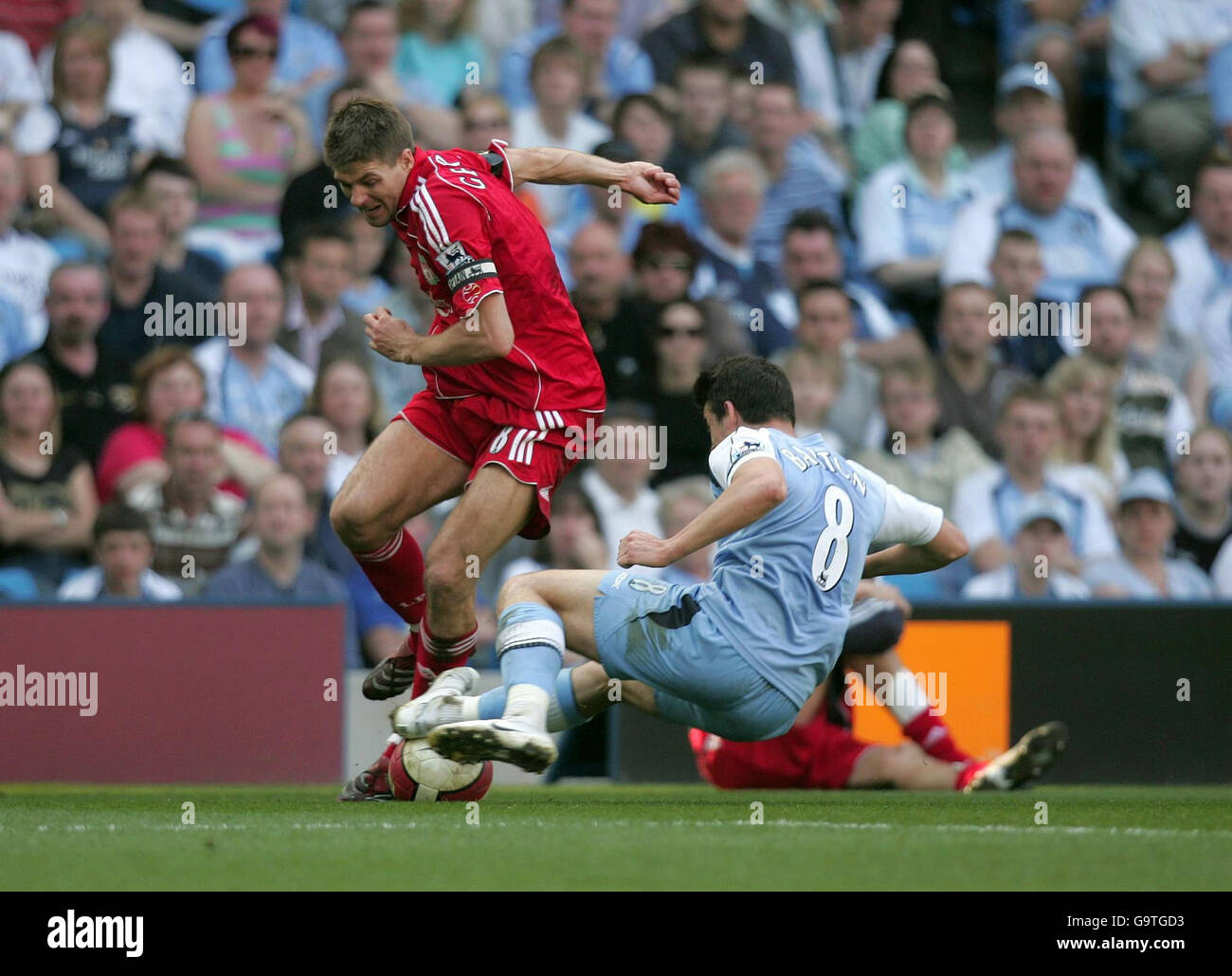 Liverpool's Steven Gerrard (left) is challenged by Manchester City's ...