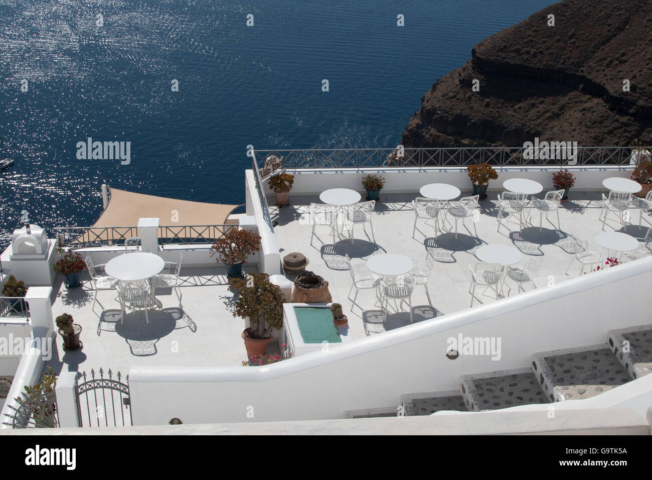 Tables set out on terrace in Fira on the Greek island of Santorini ...