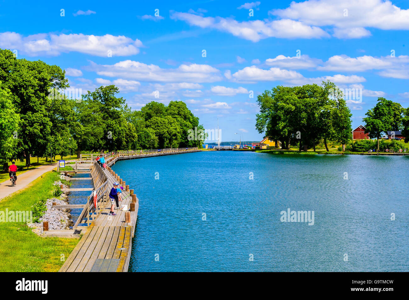 Berg, Sweden - June 20, 2016: Two boys fishing from the wooden pier for ...