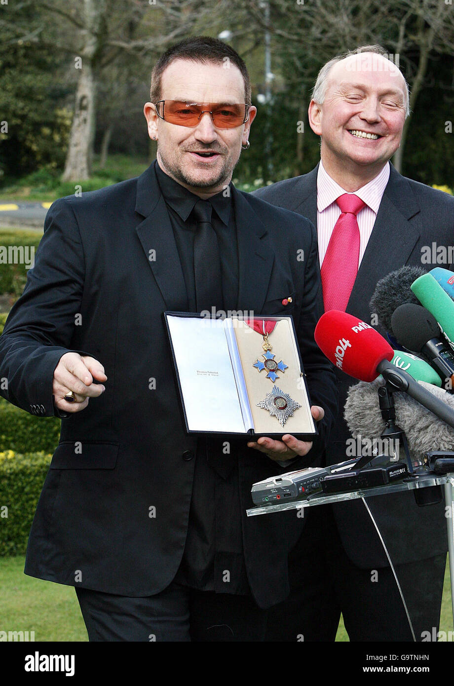 Bono, with the British Ambassador David Reddaway (right), speaks to the ...