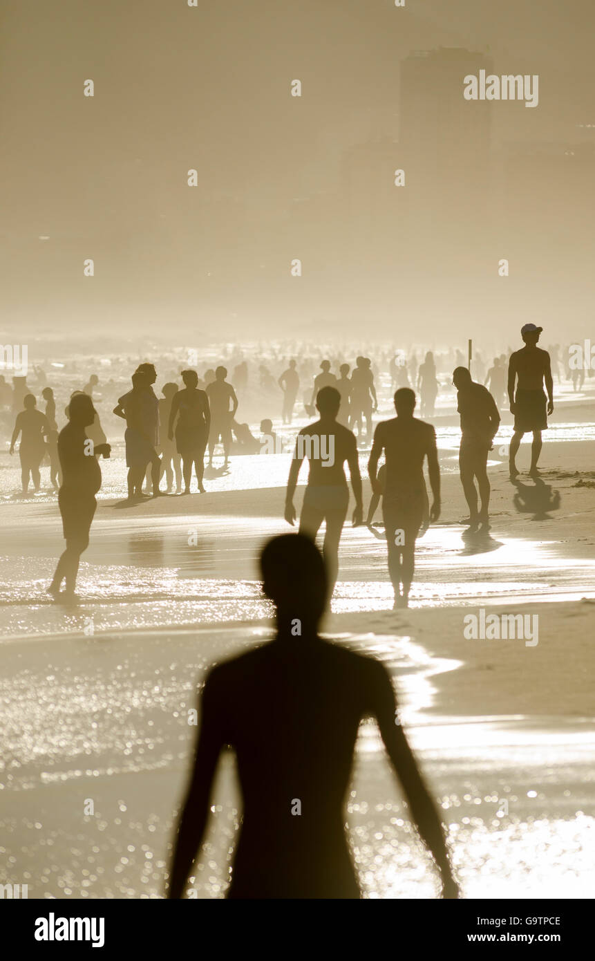 RIO DE JANEIRO, BRAZIL - JANUARY 20, 2014: Silhouettes of beachgoers ...