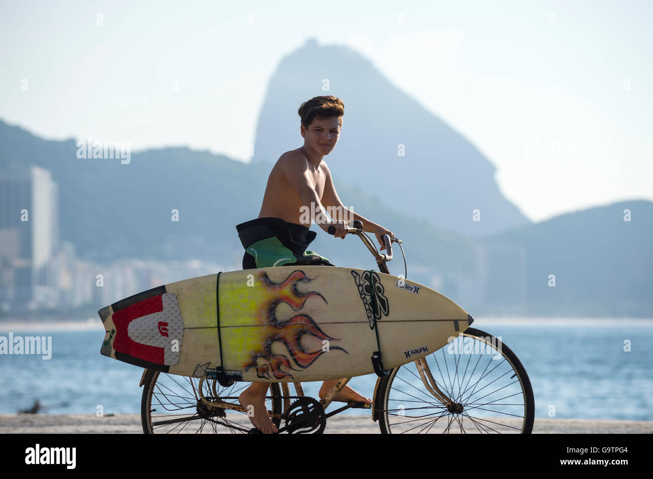 RIO DE JANEIRO - MARCH 20, 2016: Brazilian man rides a bicycle carrying ...
