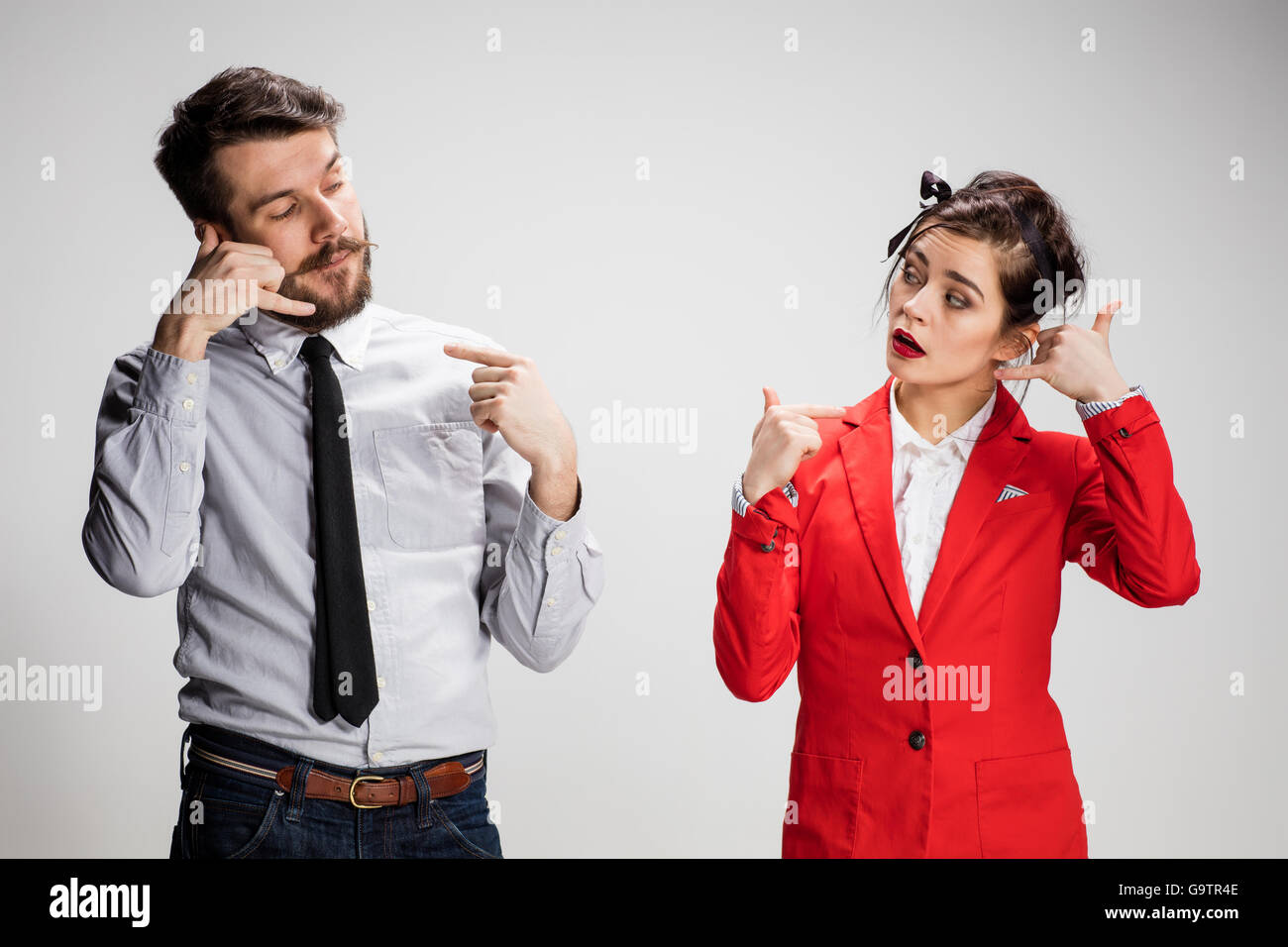 The business man and woman communicating on a gray background Stock ...