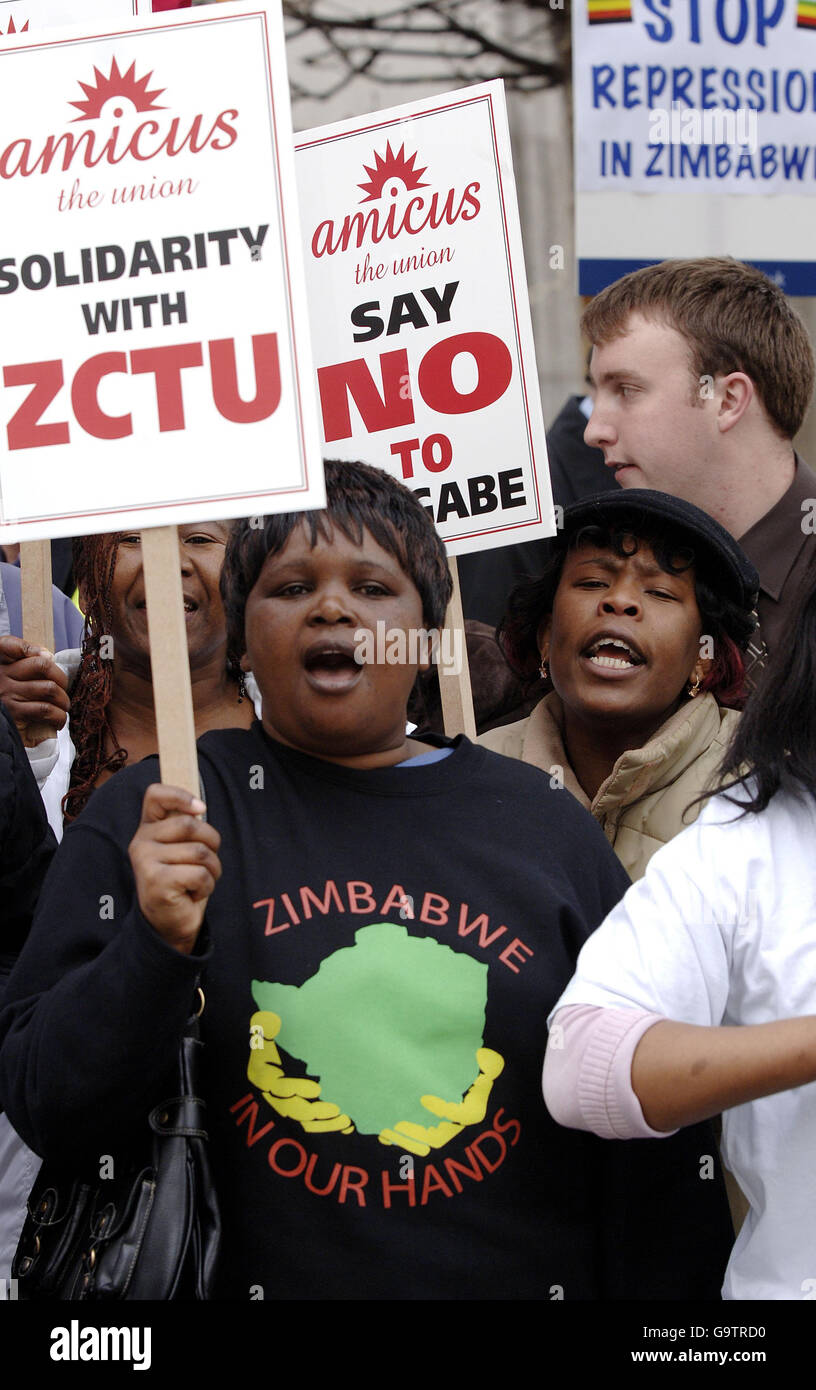 Demonstrators gather outside the Zimbabwean Embassy in the Strand ...