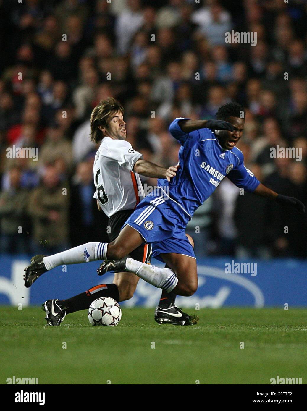 Chelsea's John Mikel (right) goes down under a tackle by Valencia's ...