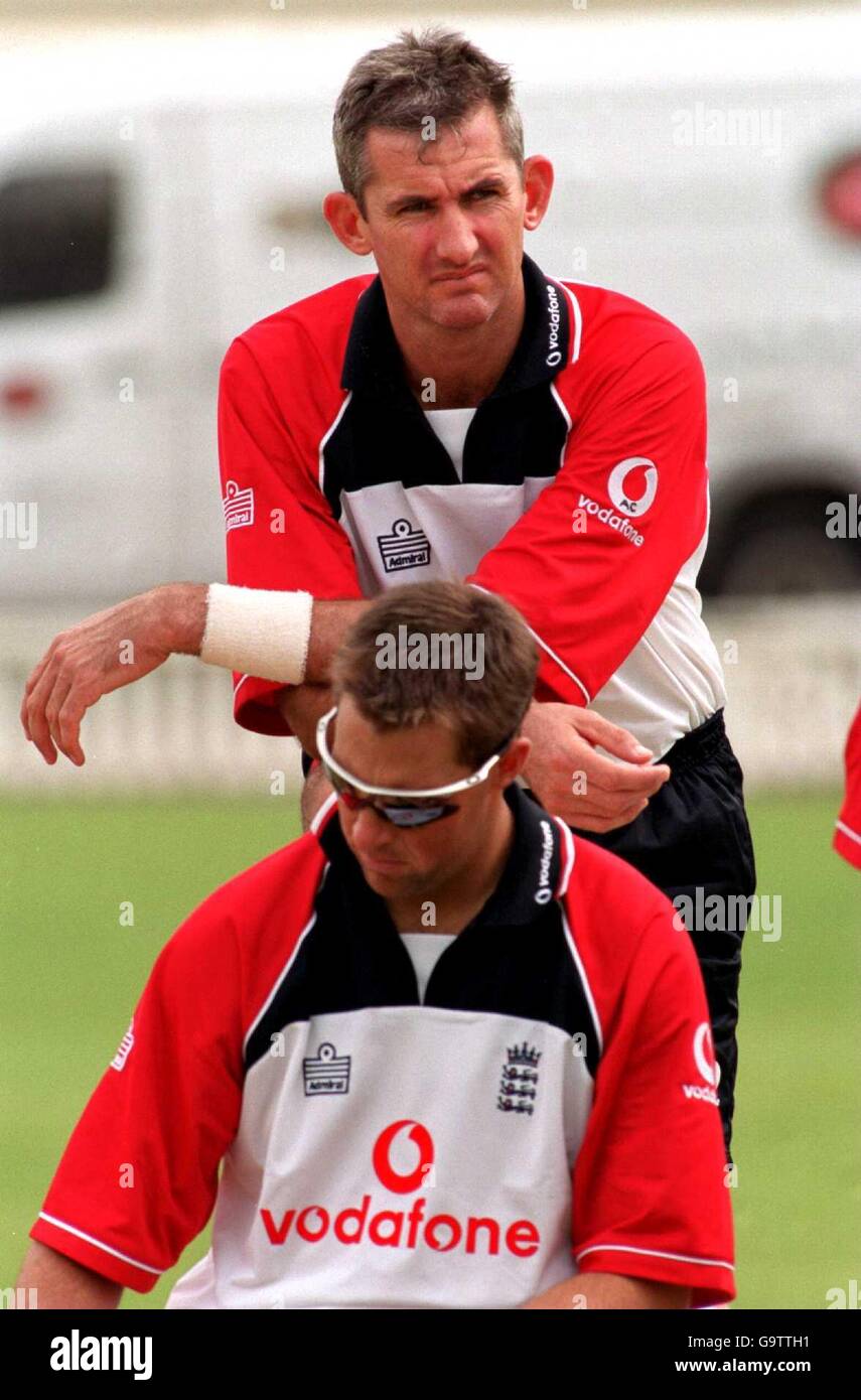 England's Andy Caddick leans on teammate Ashley Giles as they wait for ...