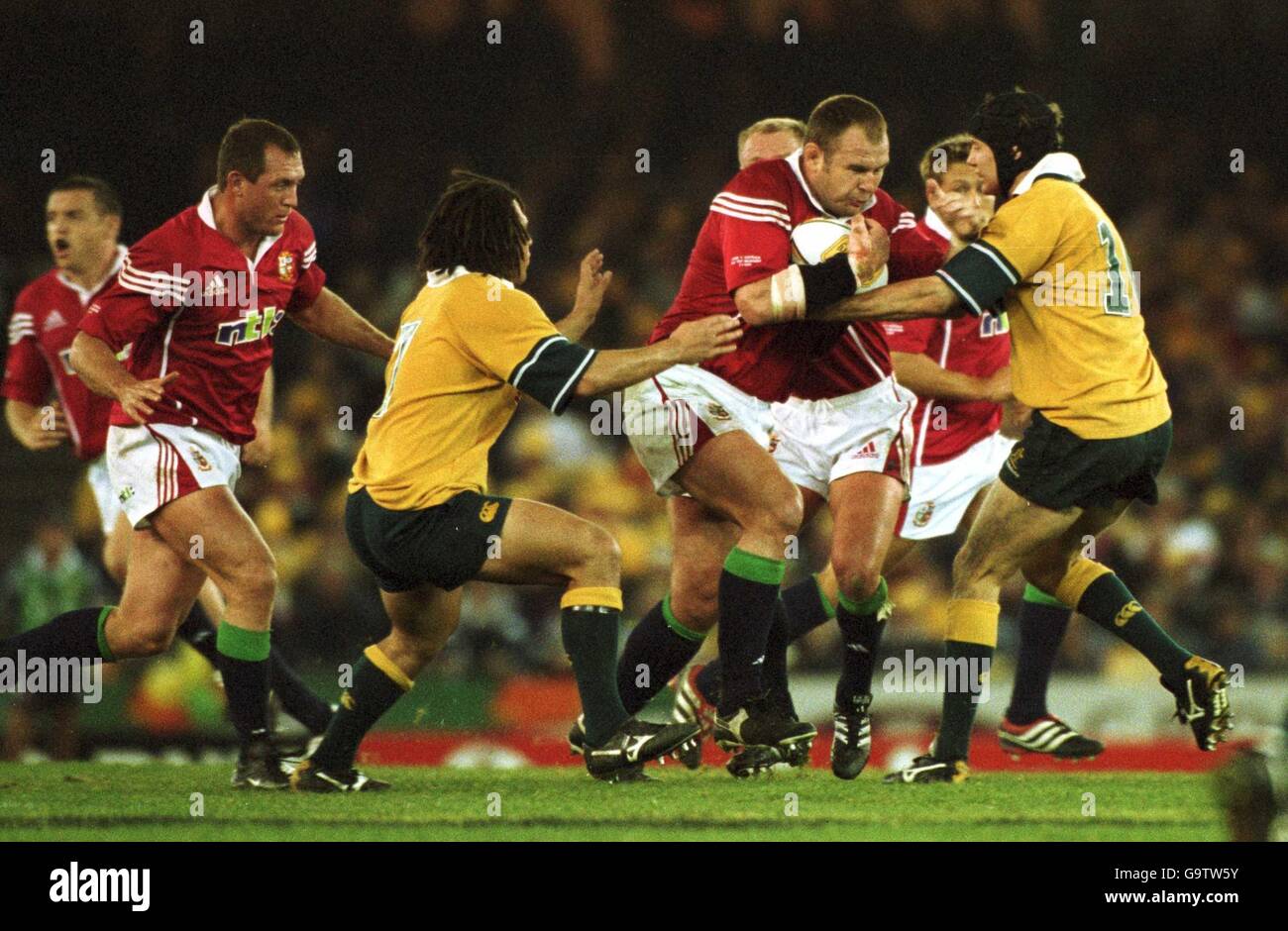 British Lions' Scott Quinnell bursts through the tackles of Australia's ...