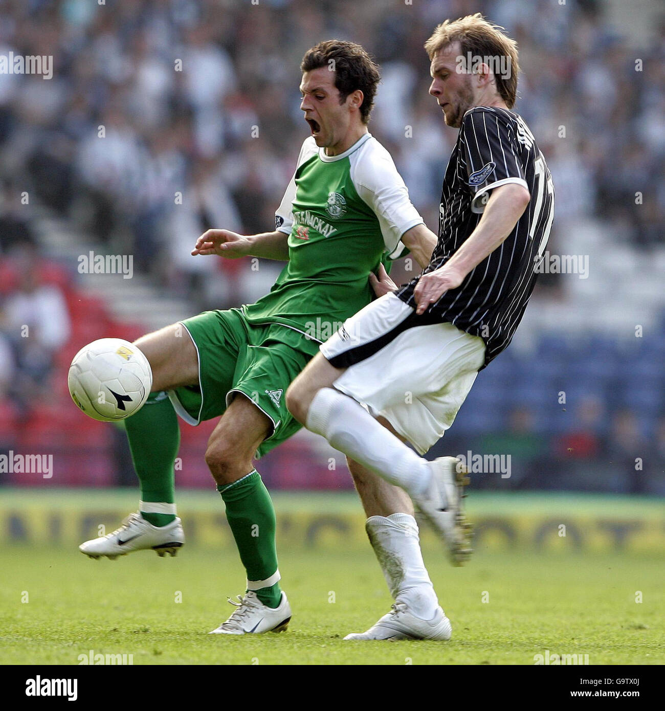 Dunfermline's Scott Muirhead (right) challenges Hibernian's Ivan ...