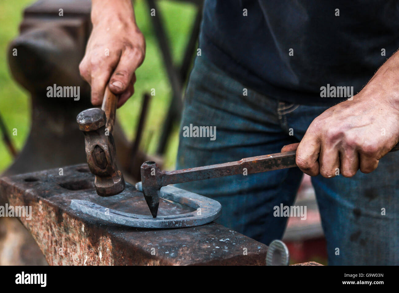 Blacksmith working very hard Stock Photo - Alamy
