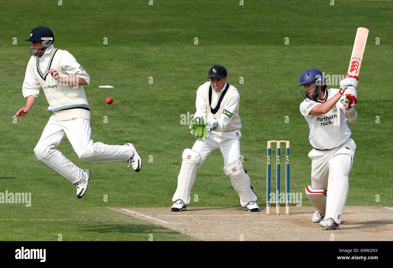 Durham's Graham Onions (right) hits the ball past Yorkshire fielder ...