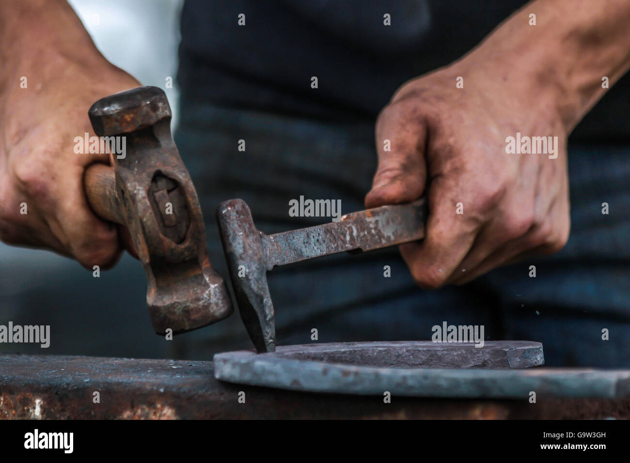 Blacksmith working very hard Stock Photo - Alamy