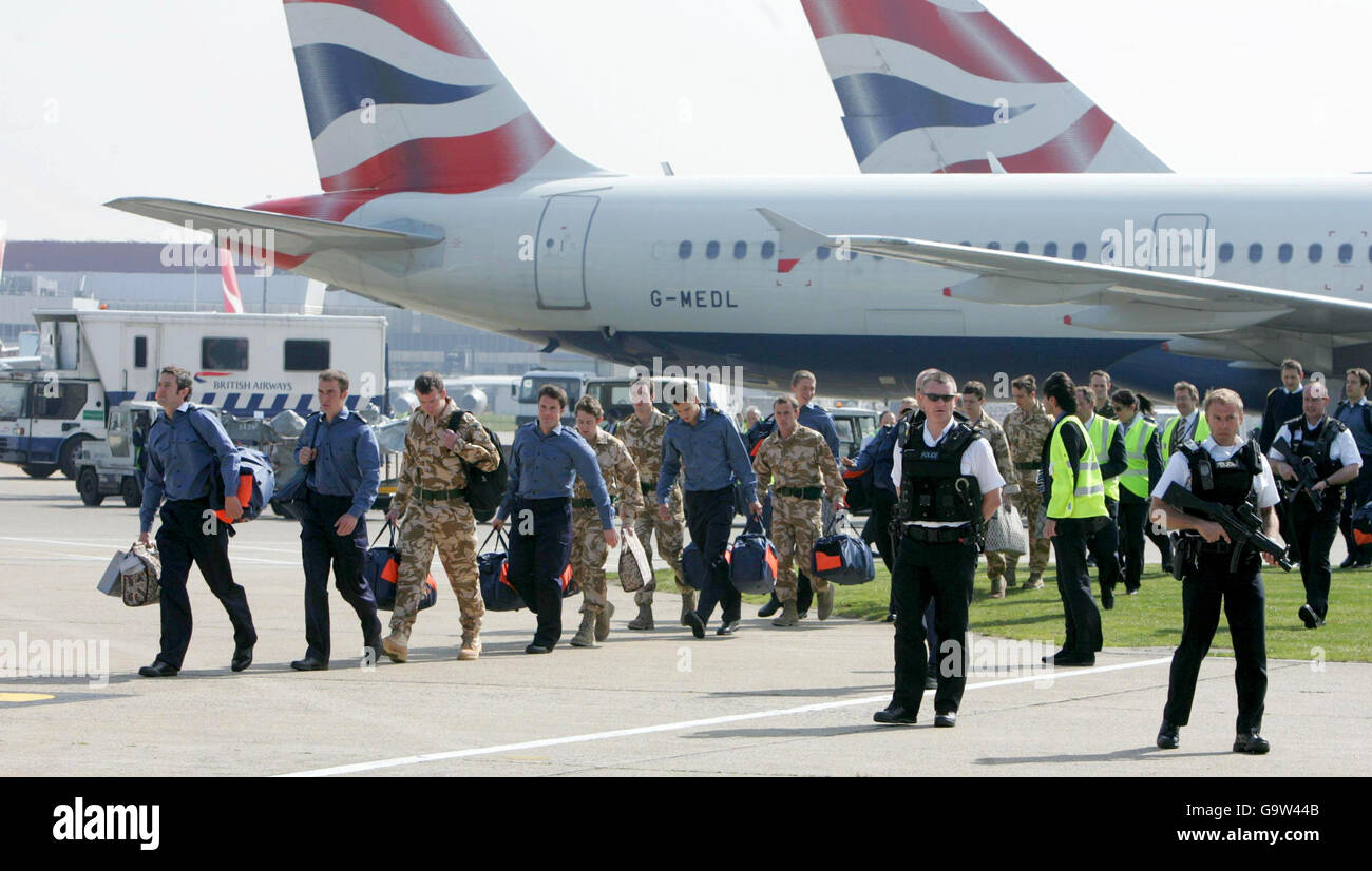 British service personnel disembark a plane at Heathrow Airport after ...