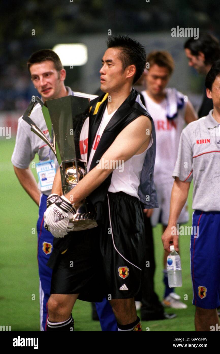 Japans yoshikatsu kawaguchi stands holding trophy hi-res stock ...