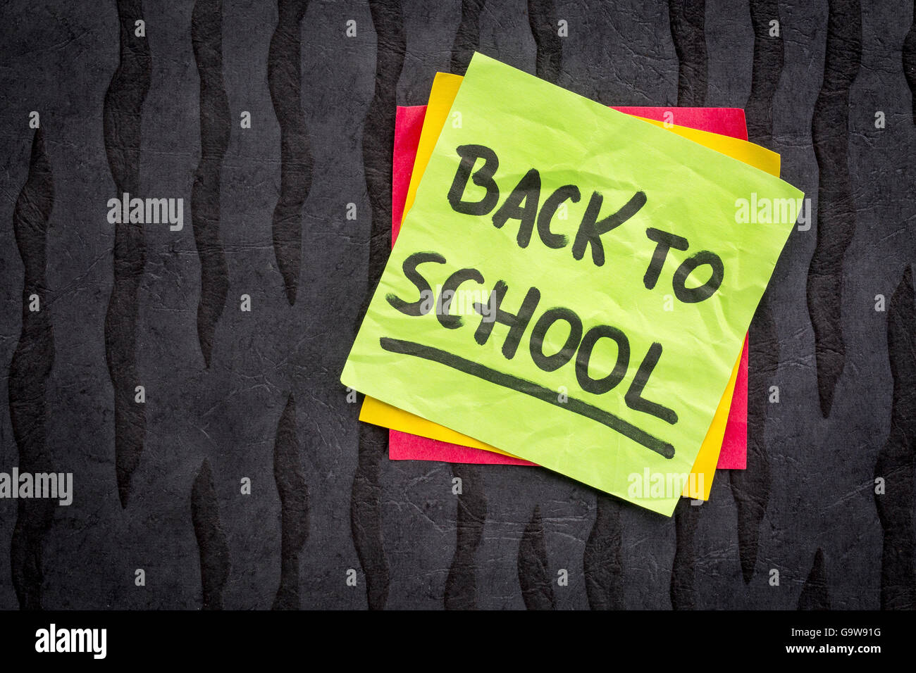 back to school reminder note - handwriting on a sticky note against ...