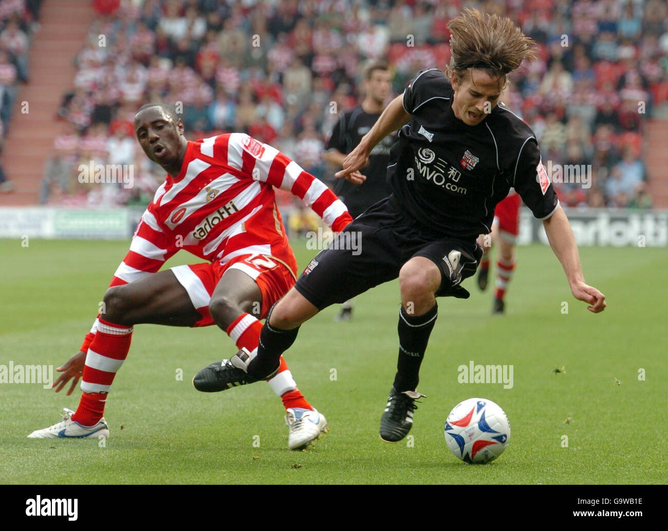 Doncaster's Jonathan Forte (left) and Brentford's Adam Griffiths tussle ...